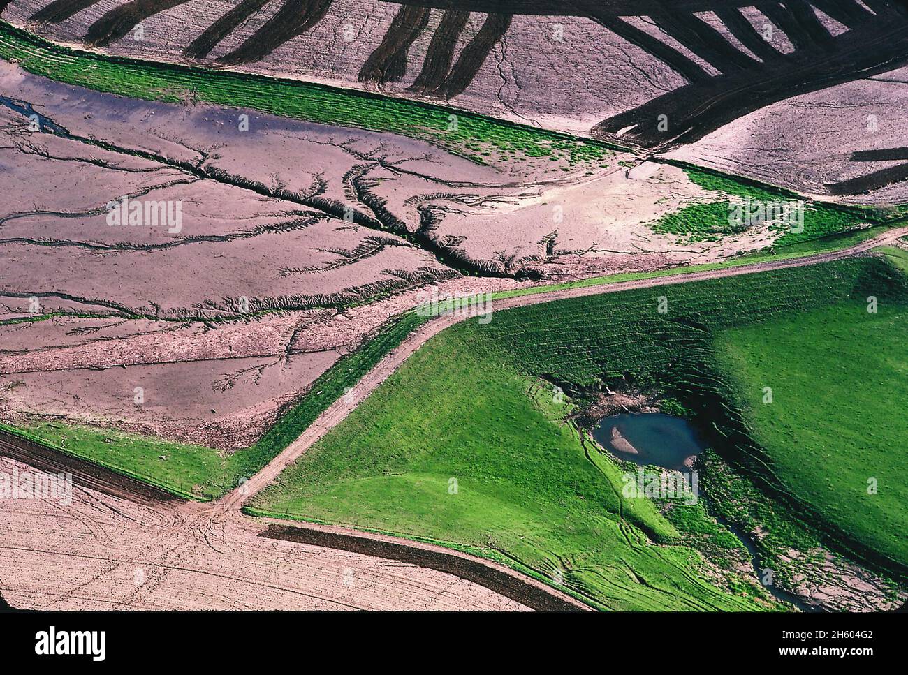A watershed dam in northwest Iowa is completely silted in, from years ...