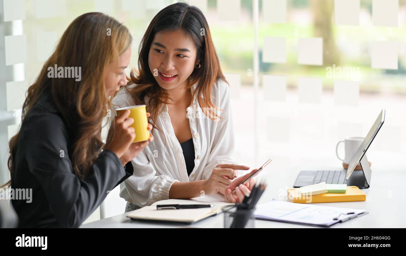 Happy cheerful employees chatting and talking about an interesting ...