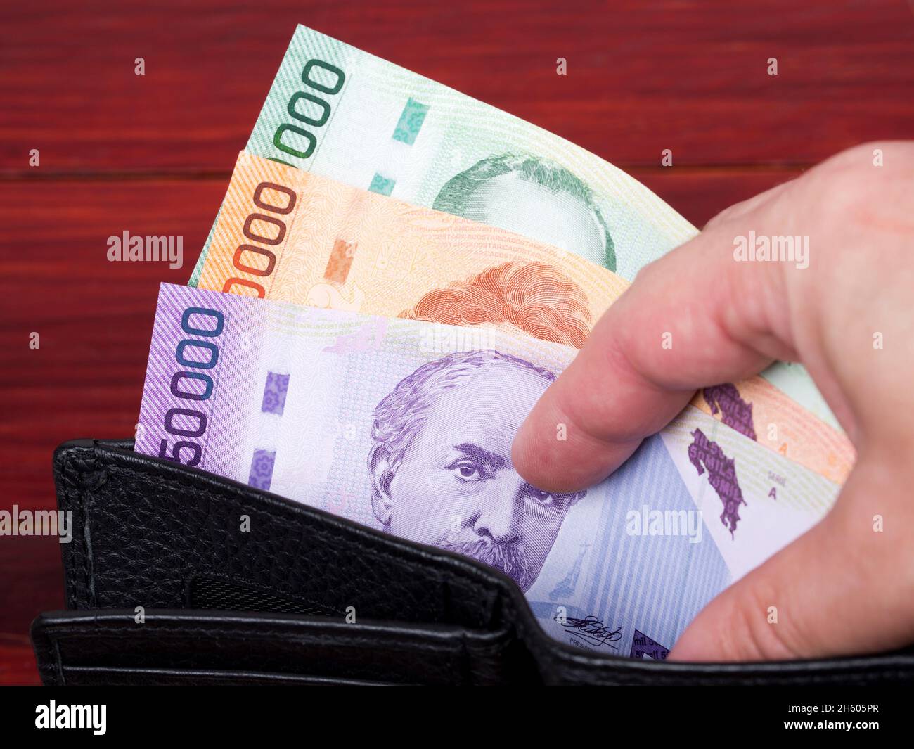 Costa Rican money - colon in the black wallet Stock Photo - Alamy
