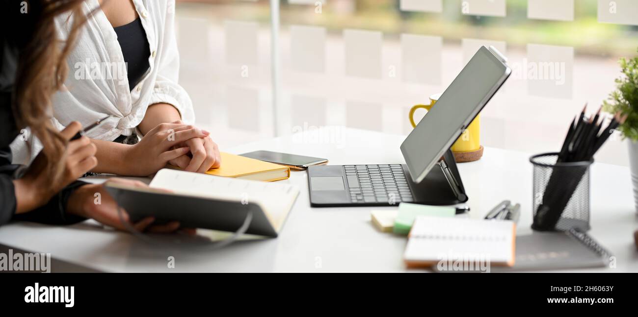 Side view of successful female manager coaching and training her ...