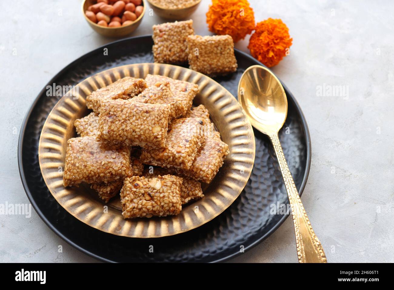 Indian makar sankranti festival food or sweets. Tilgul in a small brass ...