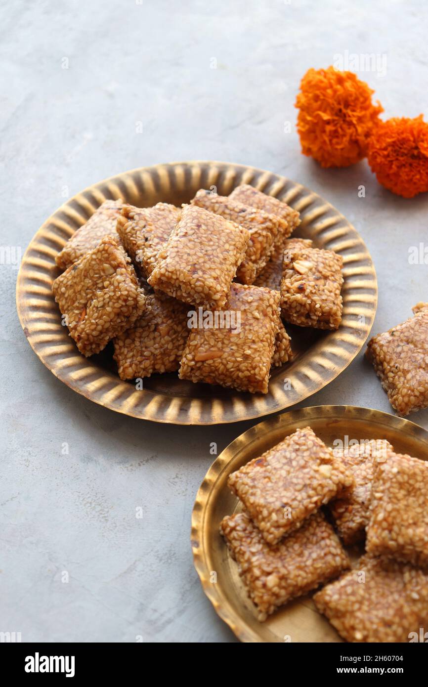 Indian makar sankranti festival food or sweets. Tilgul in a small brass ...