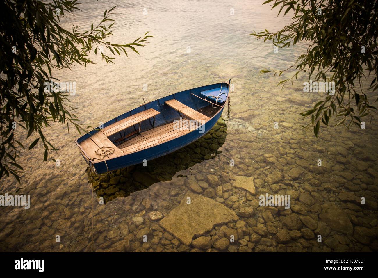 High angle image of a empty wooden boat floating on water Stock Photo ...