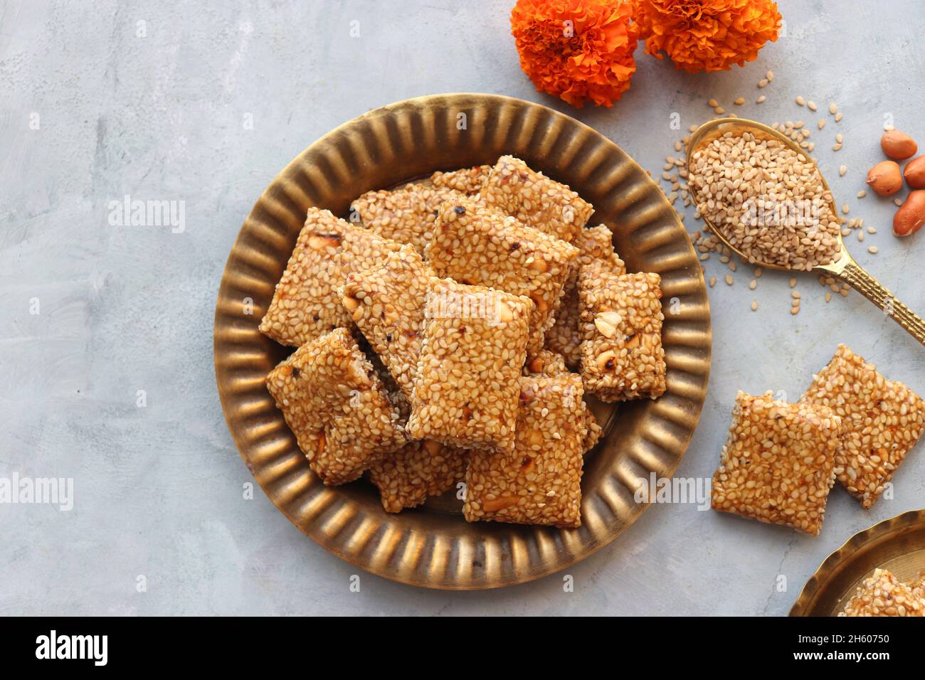 Indian makar sankranti festival food or sweets. Tilgul in a small brass ...