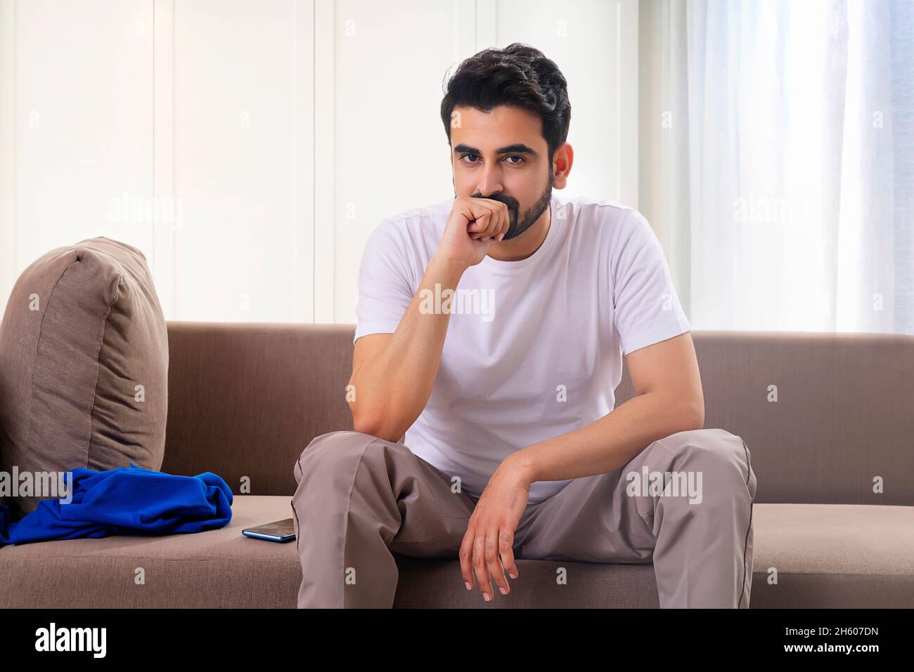 PORTRAIT OF A MAN SITTING ALONE AND THINKING AT HOME Stock Photo - Alamy