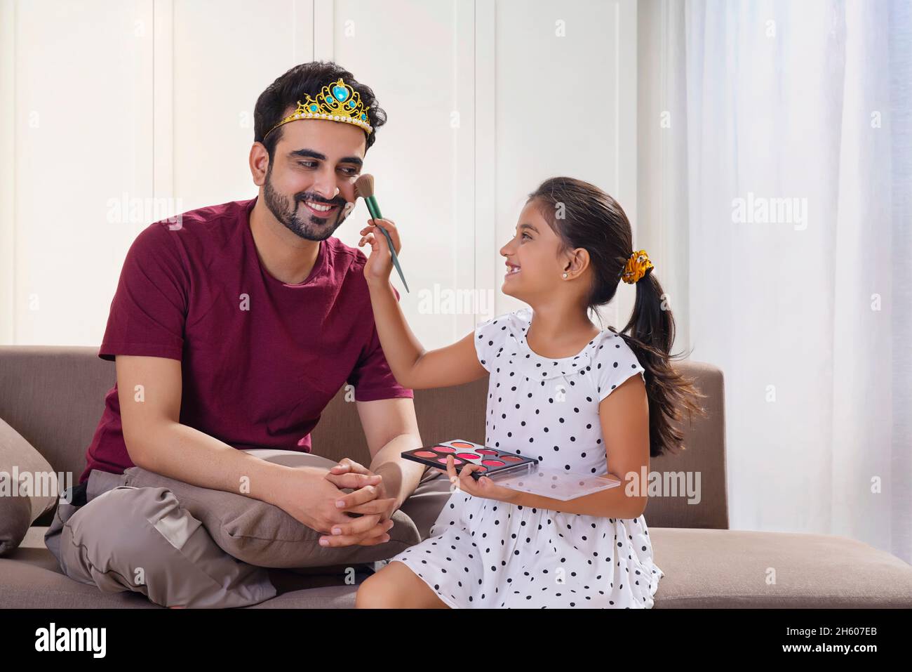A DAUGHTER HAPPILY PUTTING MAKEUP ON FATHER AT HOME Stock Photo - Alamy