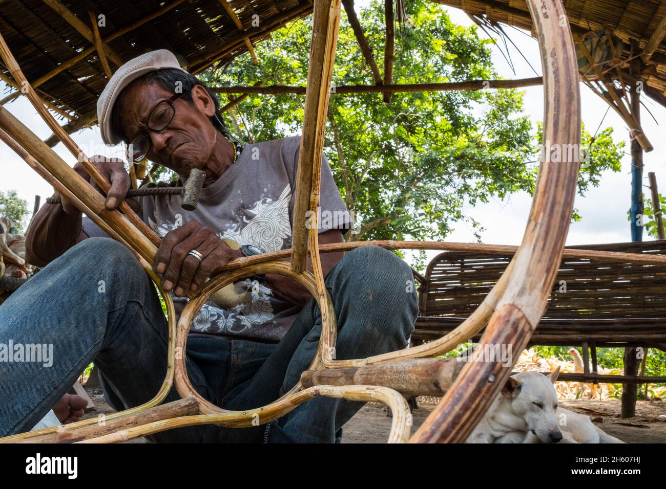 July 2017. Arenesto Deguen making an infant's walker from ratan. Local ...