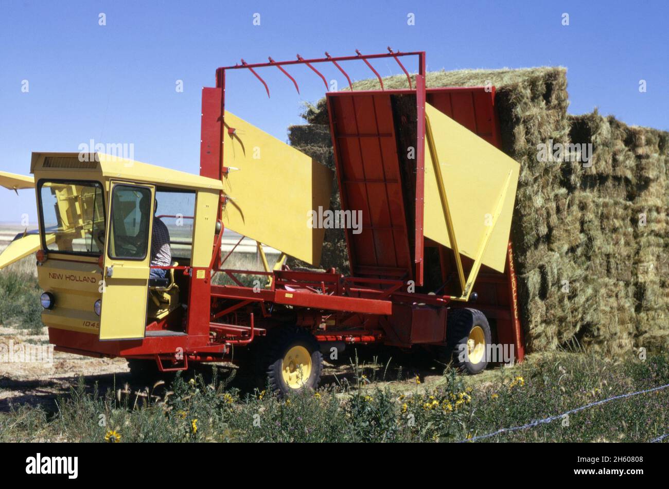 New Holland hay baler, stacking bales of hay, September 1971 Stock ...