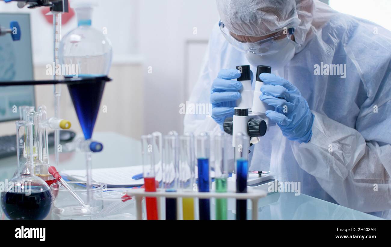 Closeup of scientist chemist doctor wearing ppe equipment analyzing ...