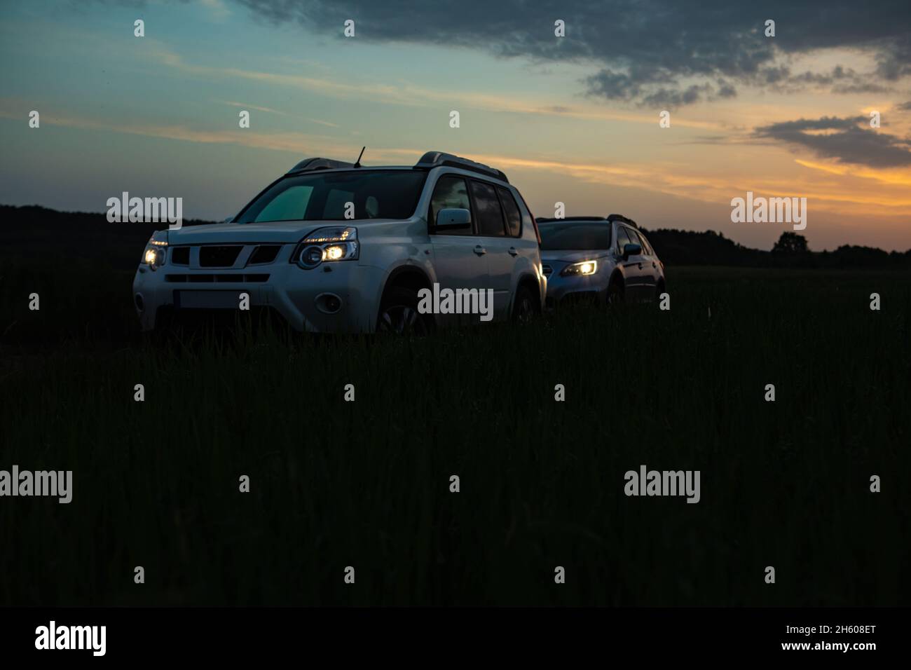 two suv cars on sunset. road trip concept. copy space Stock Photo - Alamy
