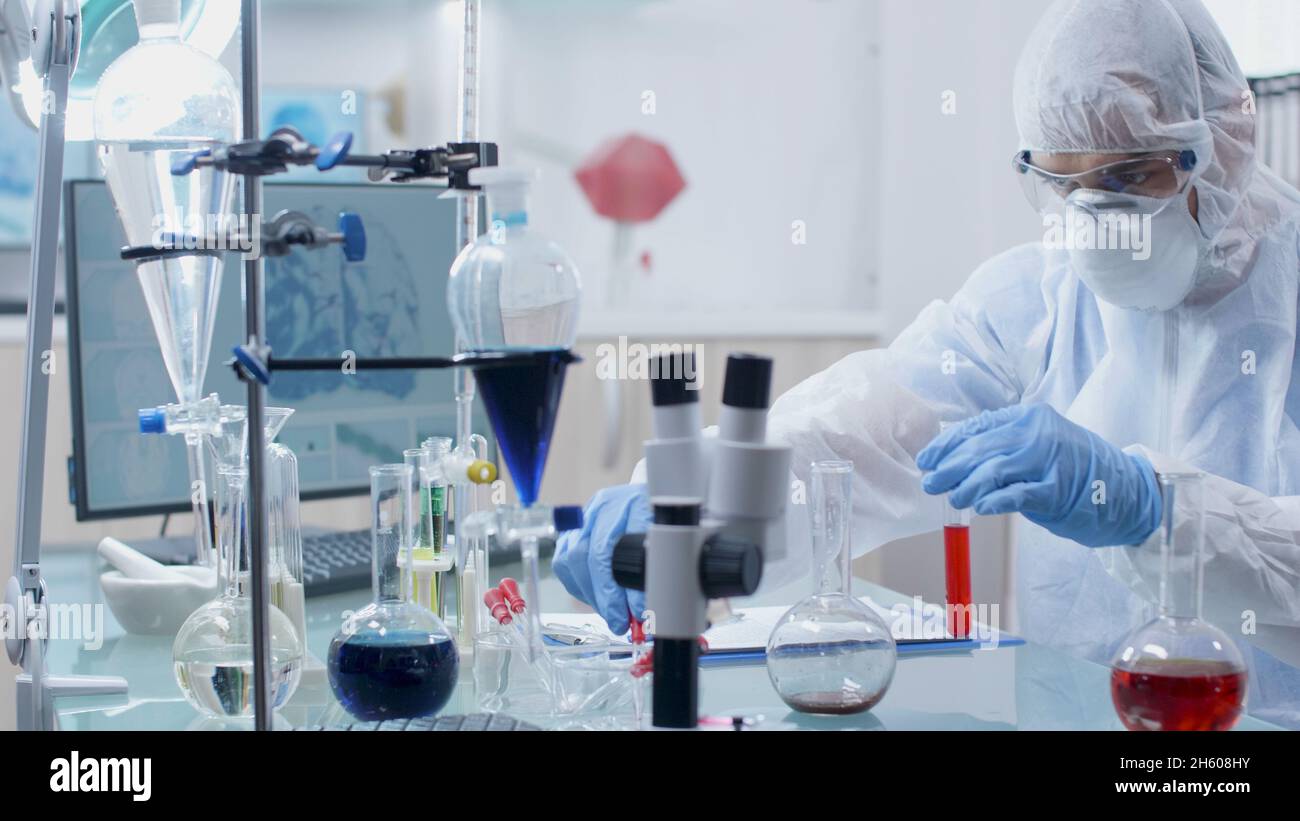 Biologist scientist researcher with ppe equipment working with medical ...