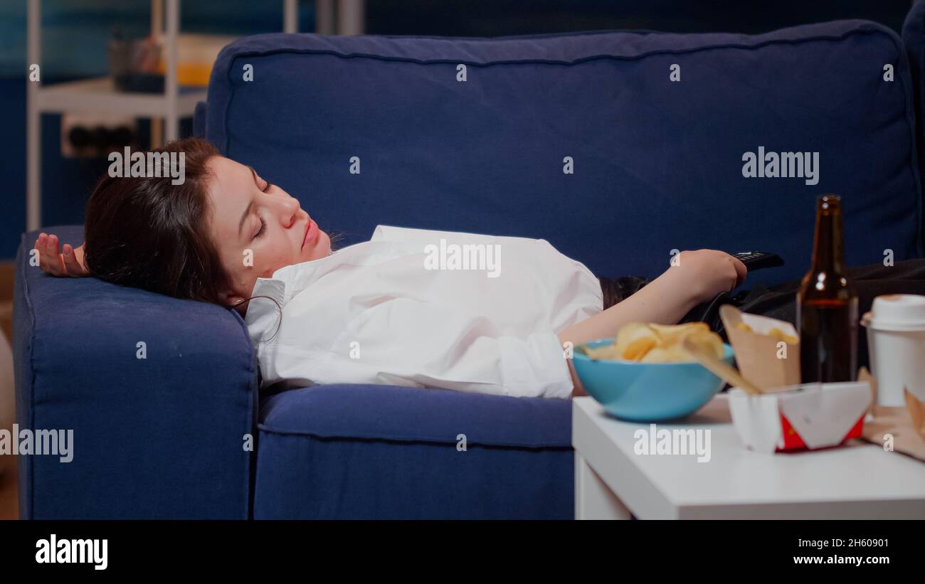 Woman laying on couch eating hi-res stock photography and images - Alamy