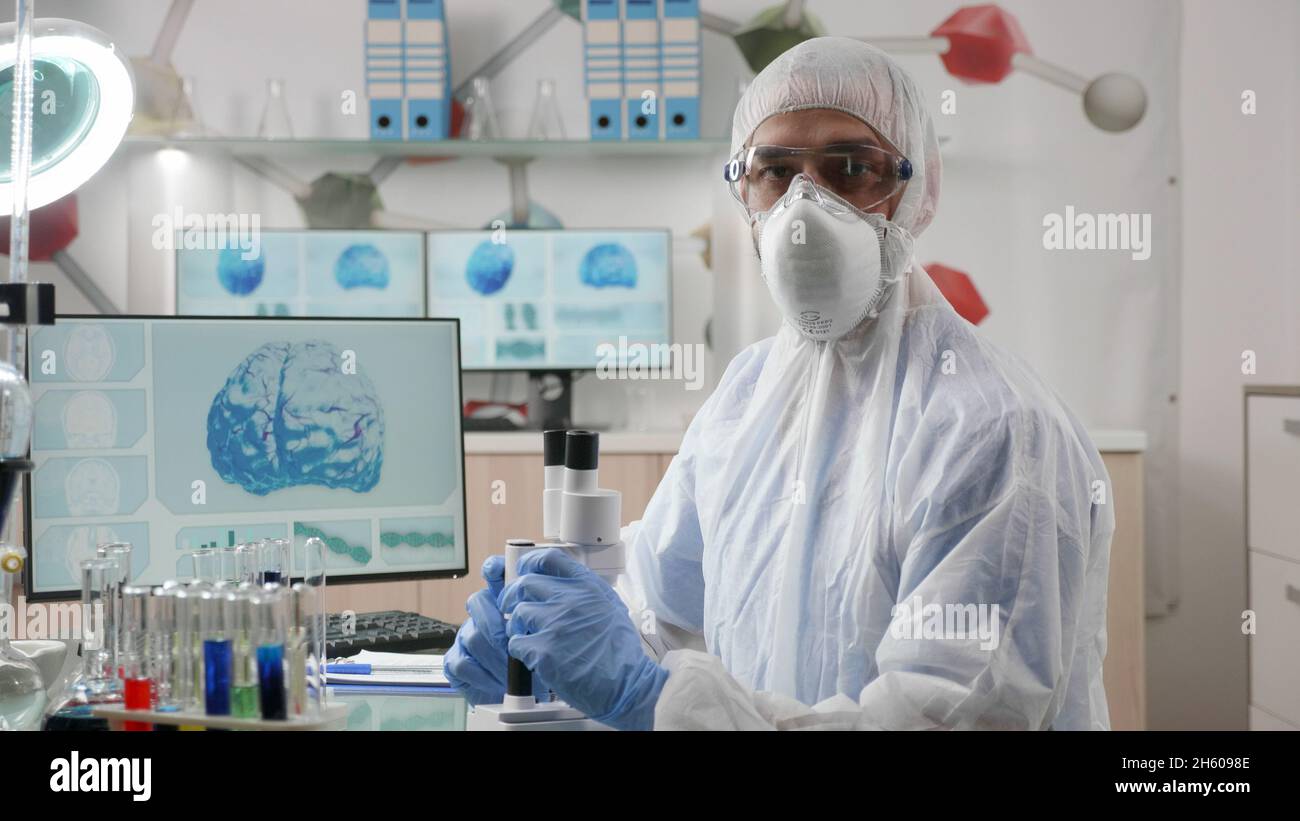 Portrait of researcher doctor with ppe equipment analyzing brain ...