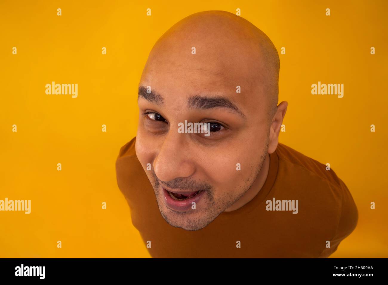 Portrait of a bald man smiling against plain background Stock Photo - Alamy