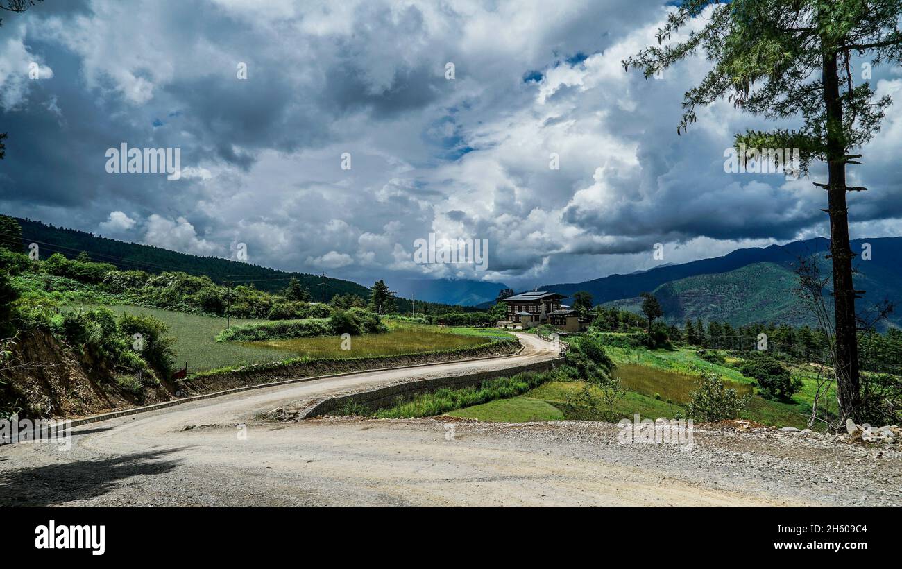 Road with a cloudy sky in Bhutan Stock Photo - Alamy