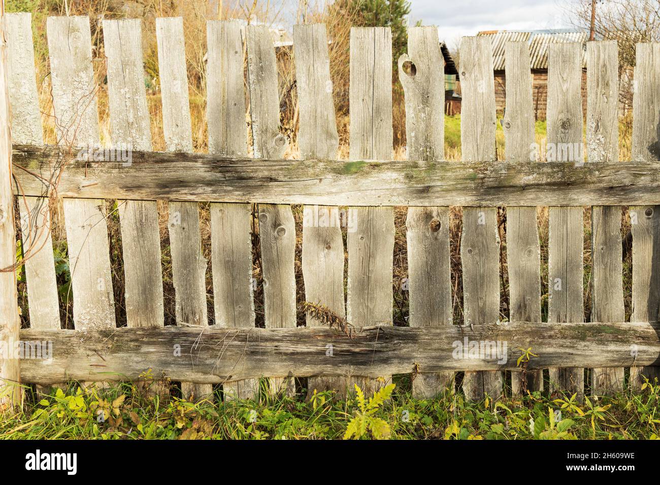 Plank surface of the rural fence enclosing the land plot in close-up ...
