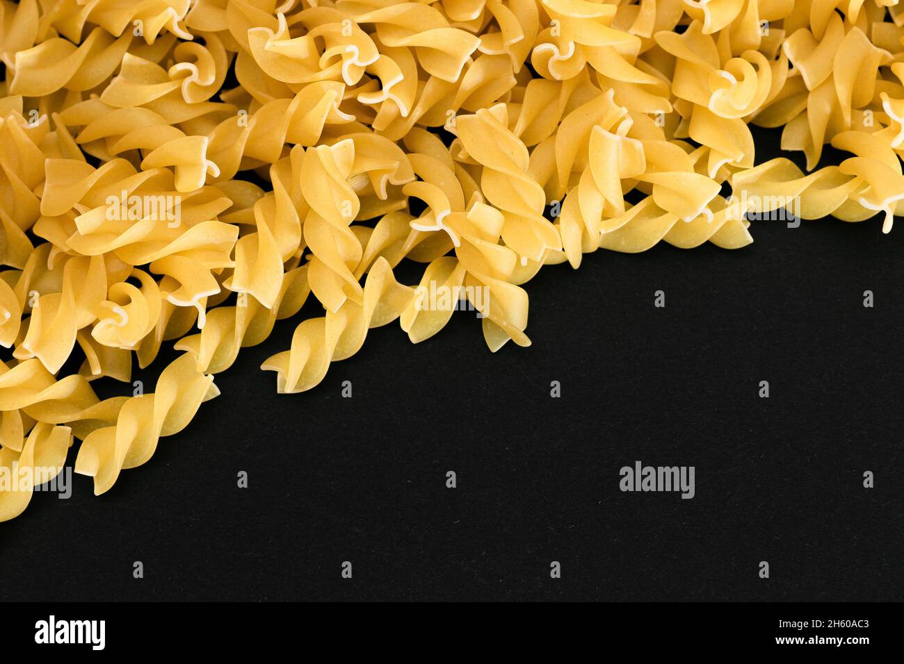 Uncooked Fusilli Pasta with Copy Space on Black Background. Raw and Dry ...