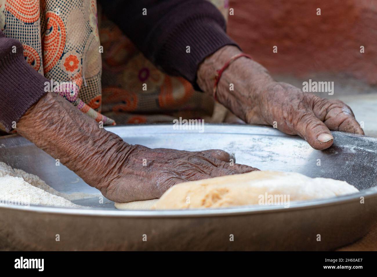 Senior woman hand making roti Stock Photo - Alamy