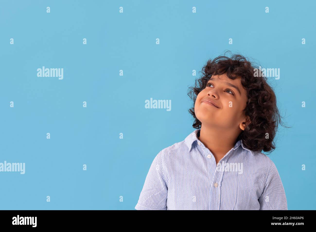 A HAPPY BOY LOOKING ABOVE AND POSING Stock Photo - Alamy