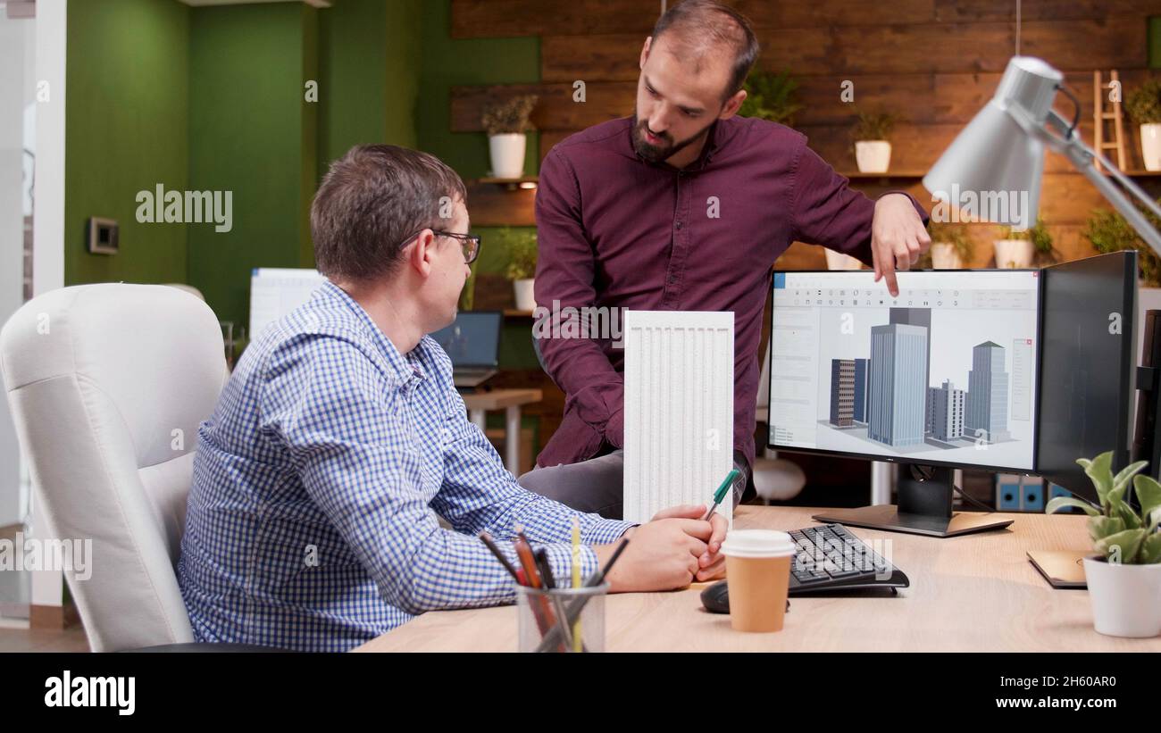 Man architect explaining building construction structure to his ...