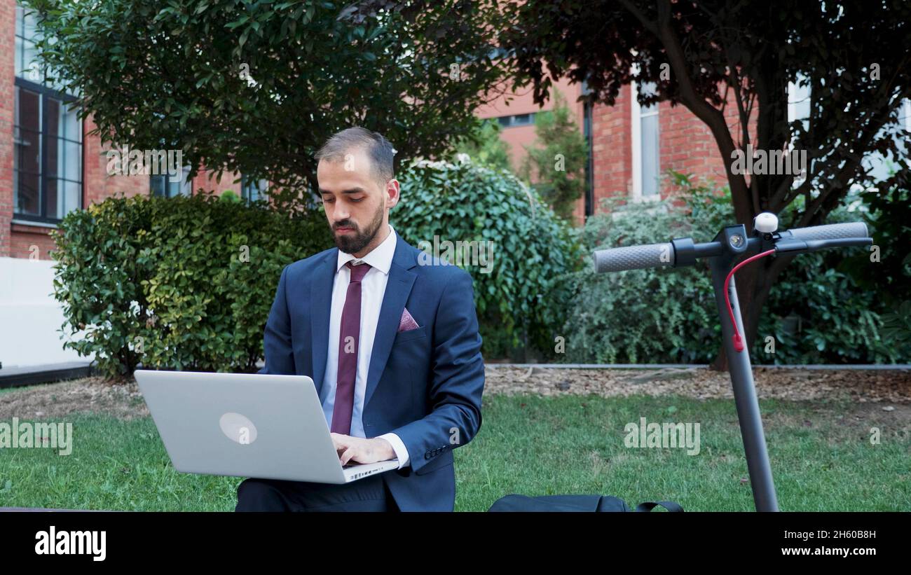 Entrepreneur looking at laptop computer screen working at management ...