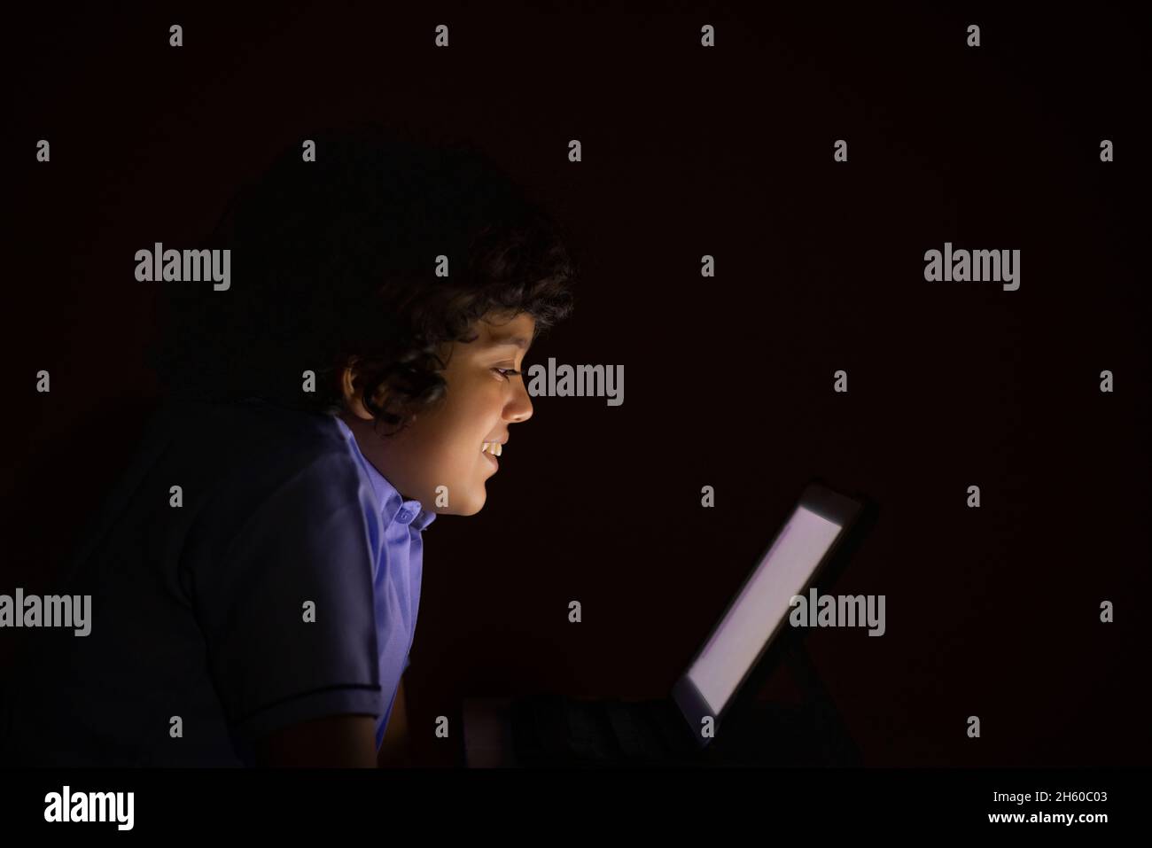 A boy happily watching tablet at home Stock Photo - Alamy