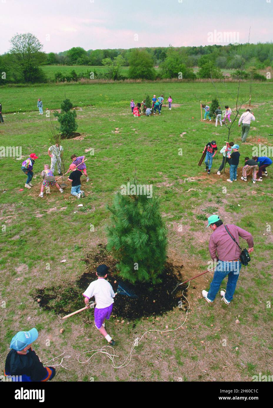 Students at Centreville Middle School plant trees as part of an outdoor ...