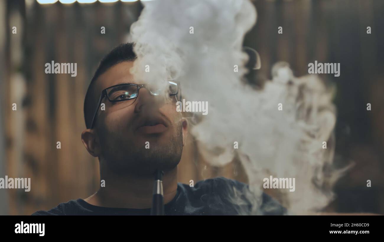 Arabic jordanian young man smokes a hookah Stock Photo - Alamy