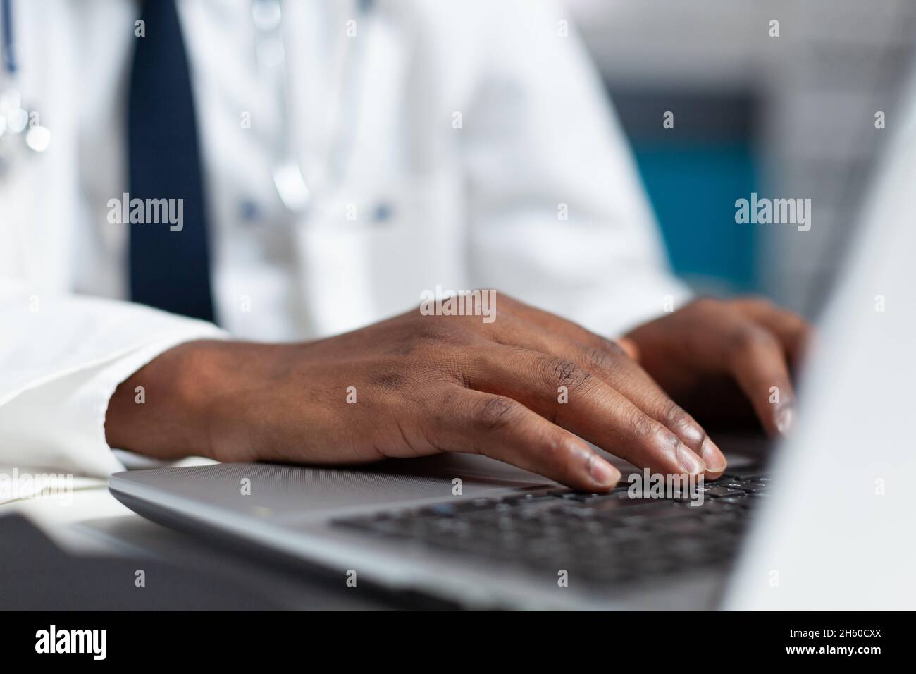 Closeup of african american doctor hand typing medical prescription ...