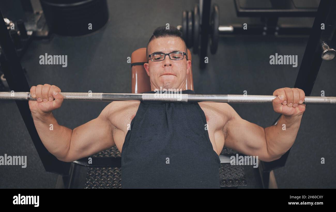 An Arab man shakes his chest with a barbell lying down Stock Photo - Alamy