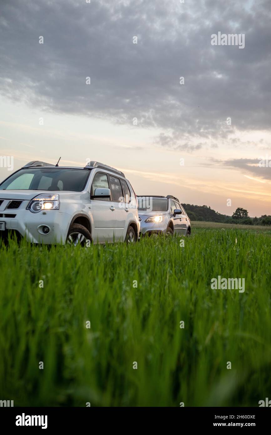 two suv cars on sunset. road trip concept. copy space Stock Photo - Alamy