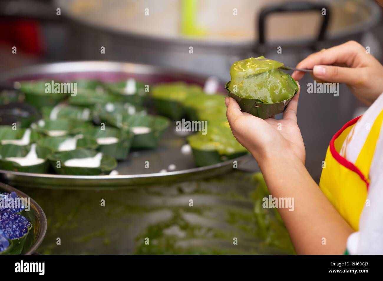 people making traditional Thai glutinous rice flour sweet pandan leaf ...