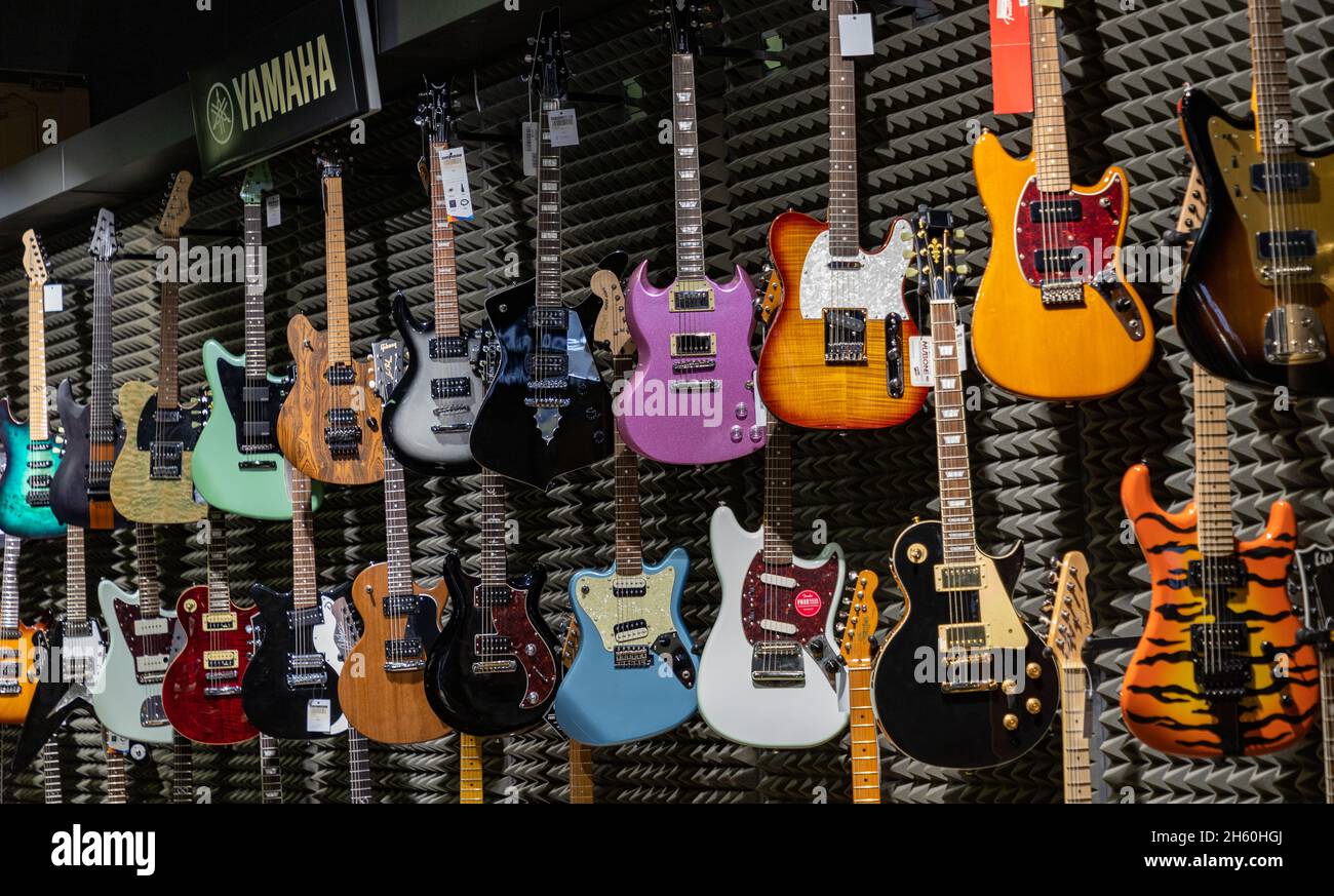 A picture of many different guitar models being sold in a shop Stock ...