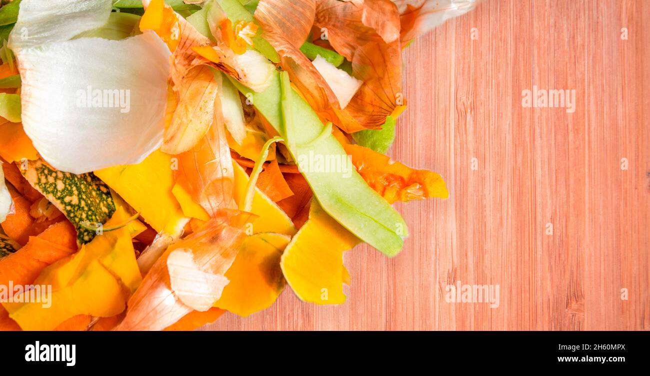 Fruit and vegetable peels of different colors on the wooden table ...