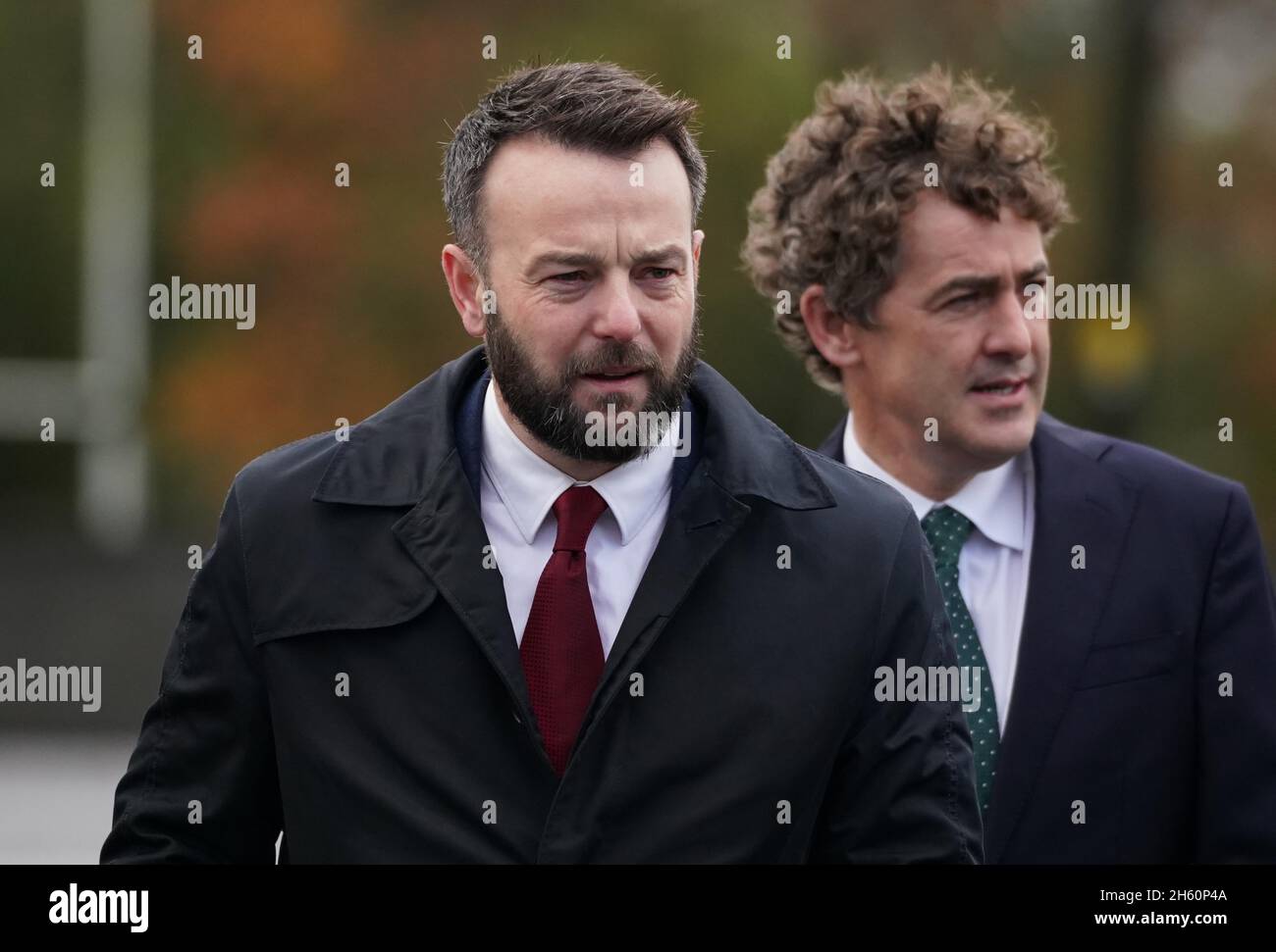 SDLP leader Colum Eastwood (left) arrives for the Requiem Mass of ...
