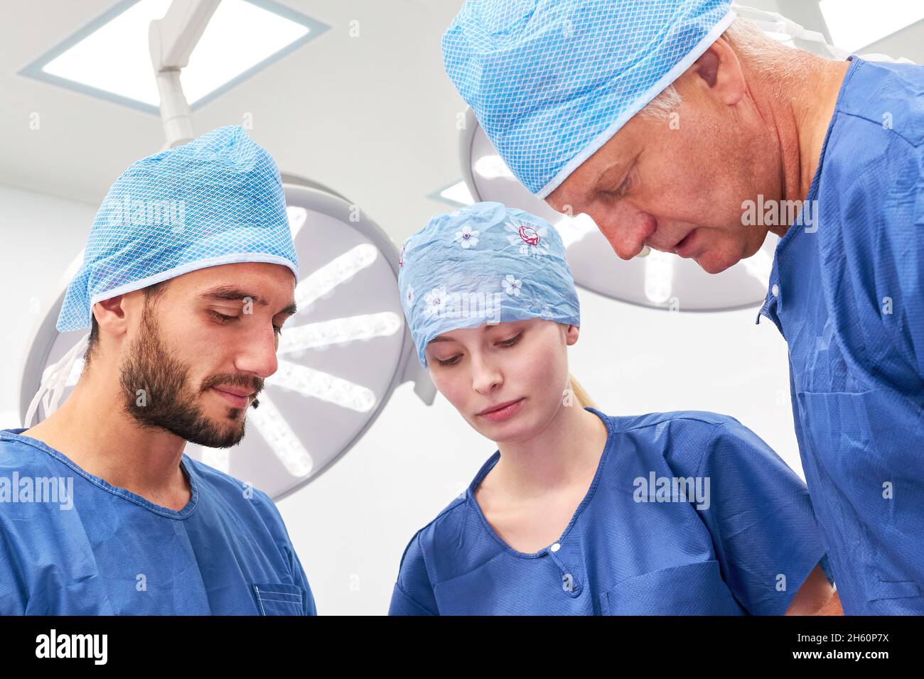 Senior physician and surgery doctors team discuss and plan an operation ...