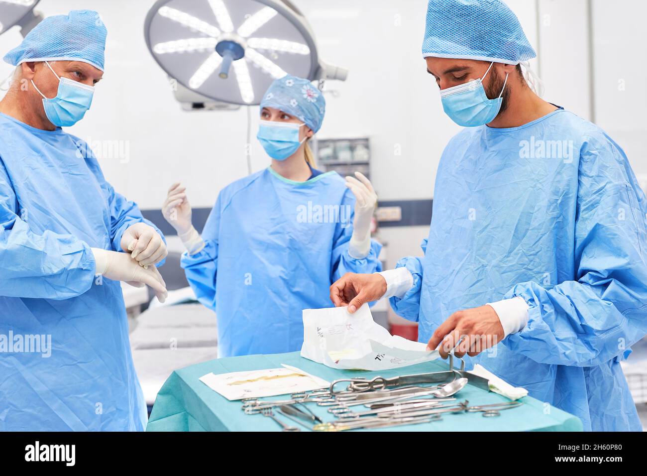 Surgery team in protective clothing with sterile surgical instruments ...