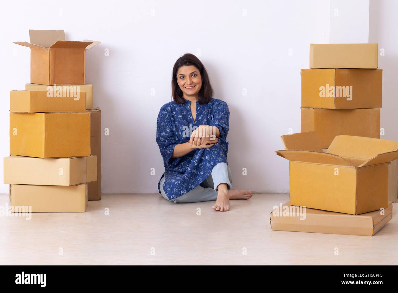 Indian woman taking rest during shifting to new home Stock Photo - Alamy
