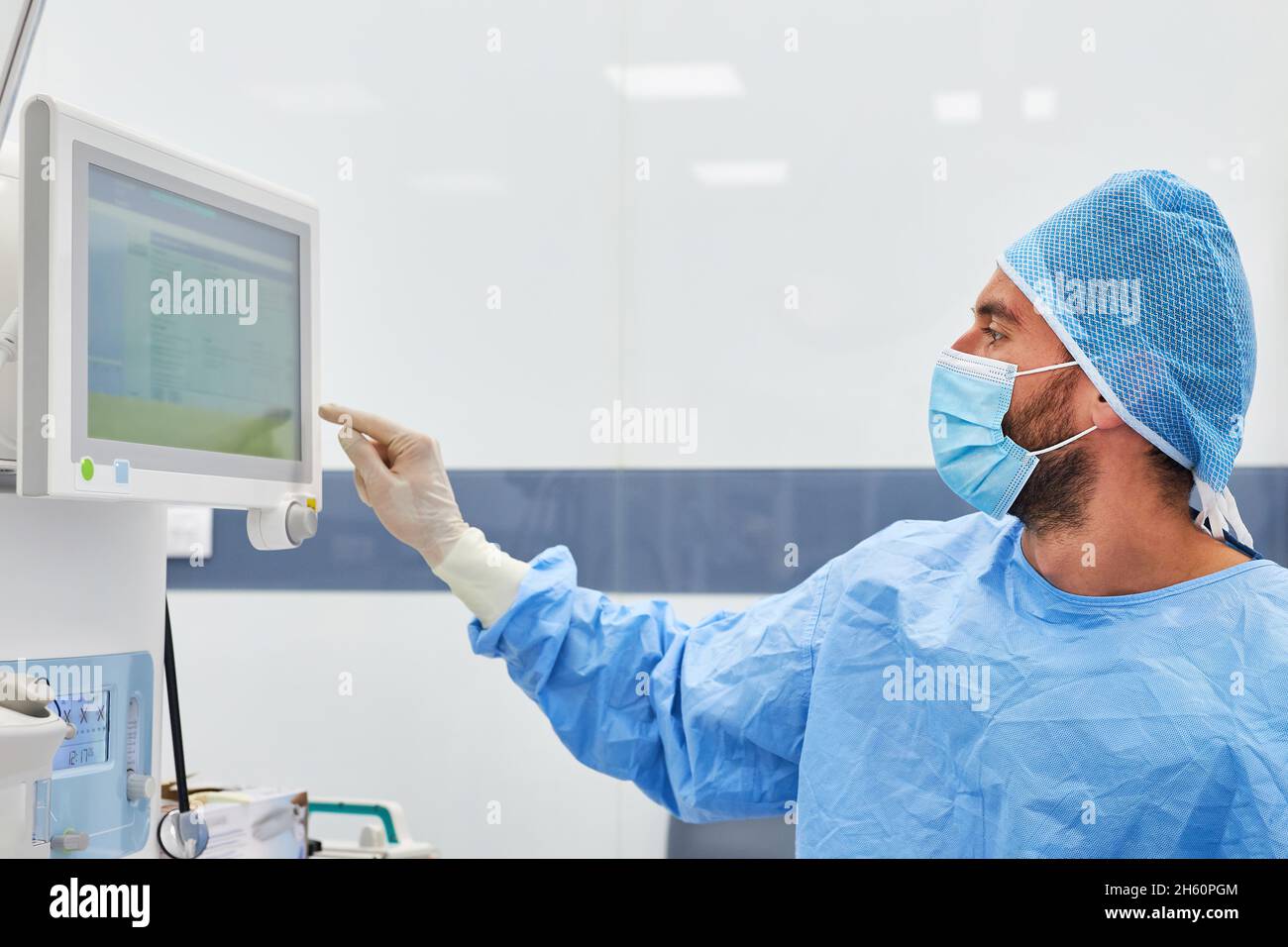 Surgeon or anesthetist operates monitor at the anesthesia workstation ...