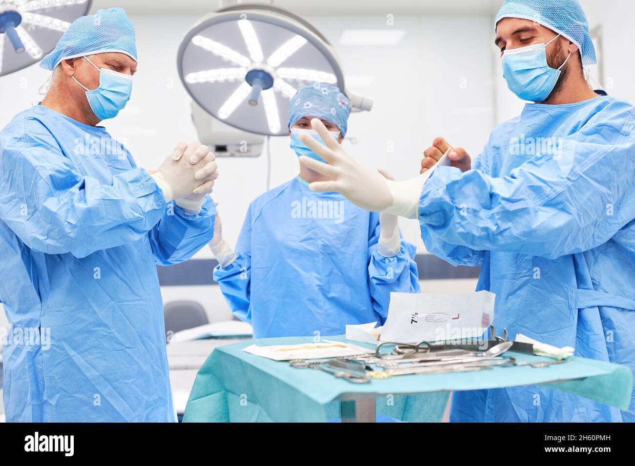 Surgery medical team in protective clothing and with sterile gloves ...