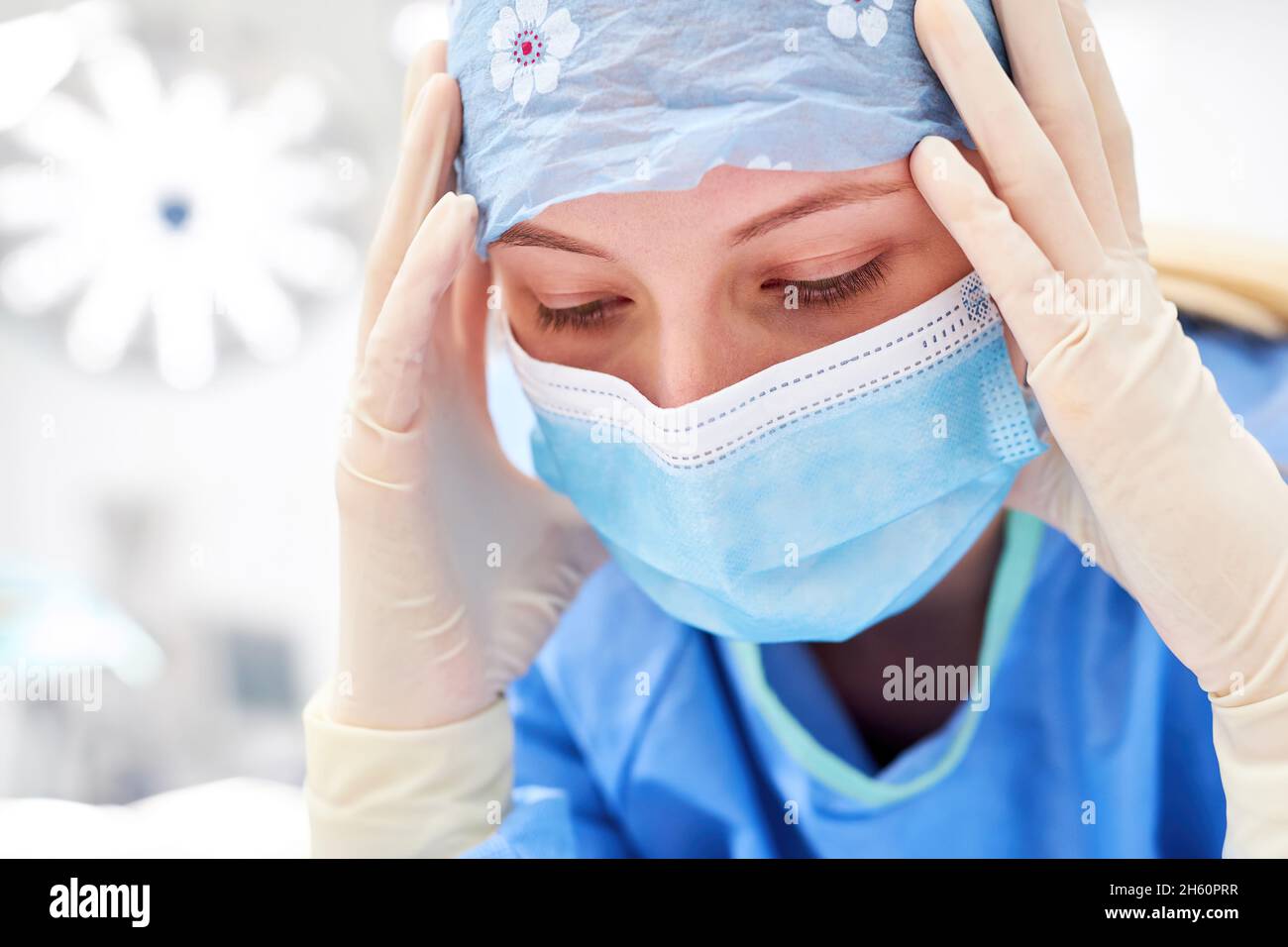 Surgical nurse or nurse with hands on head for overwork and exhaustion ...