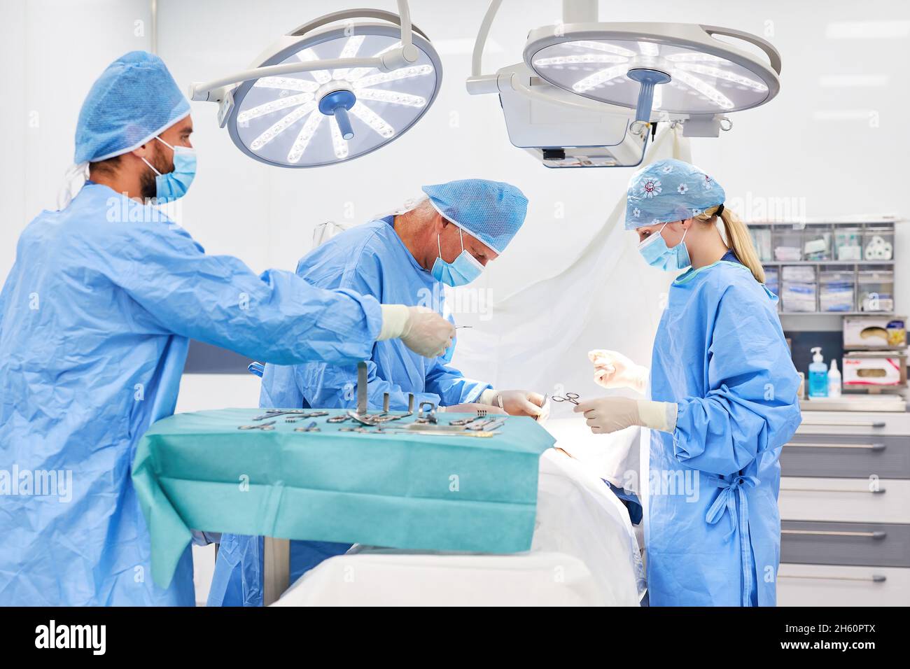 Group of doctors in surgery during an operation on a patient in the ...