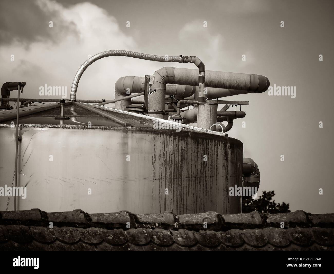 Grayscale shot of an industrial facility with tanks and pipes Stock ...