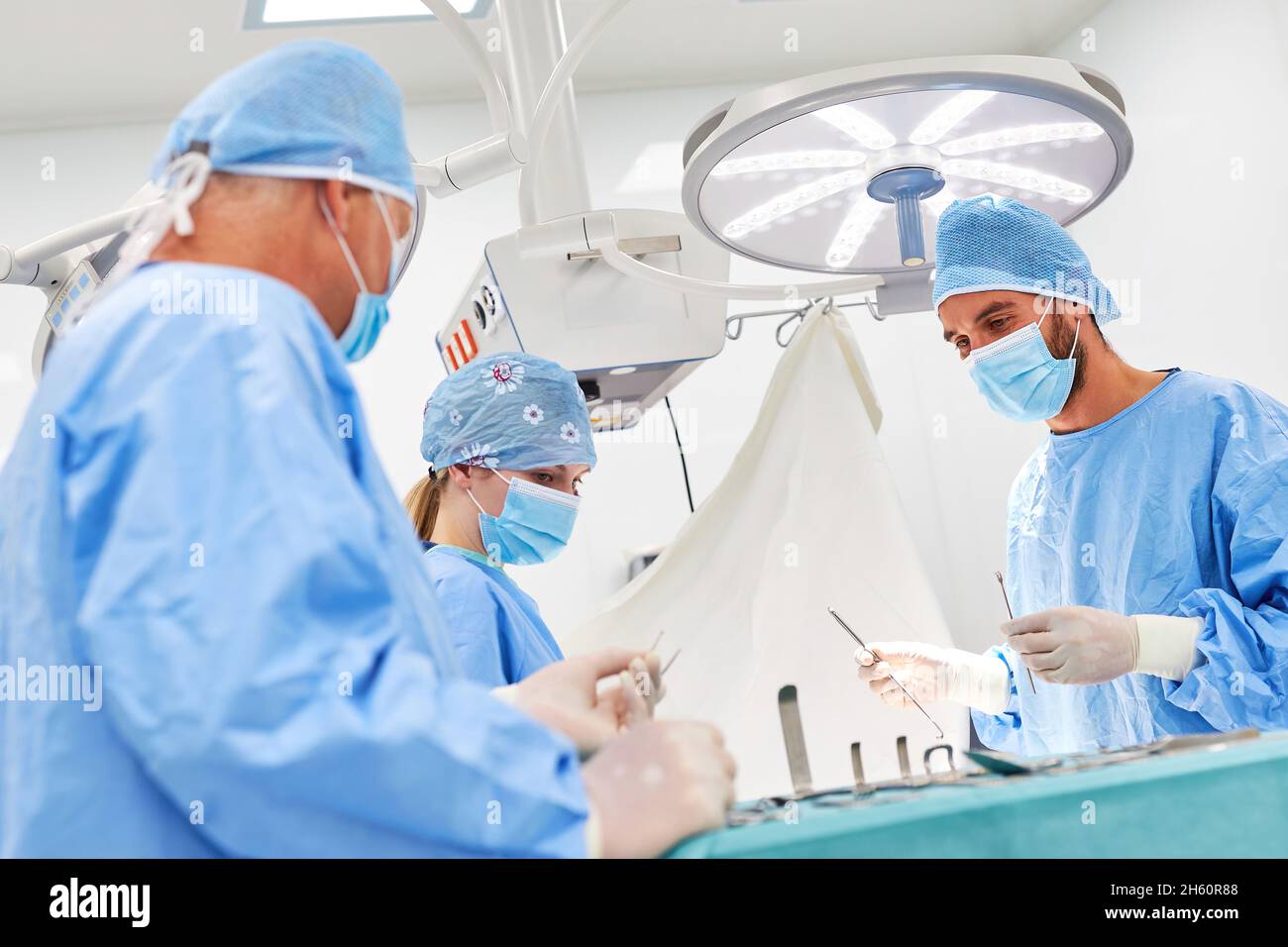 Surgery team performing an operation on a patient in the operating room ...