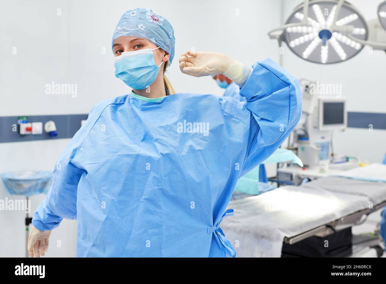 Exhausted nurse stretching from overwork after strenuous operation ...