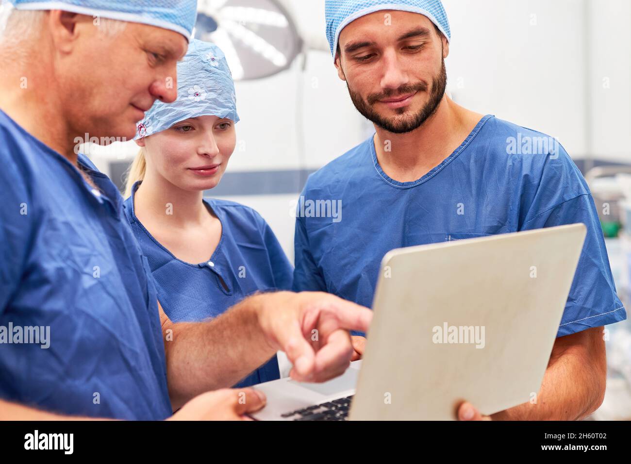 Surgery medical team with laptop computer during surgery planning in ...