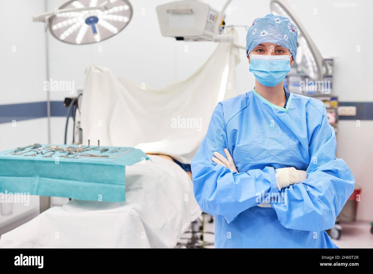Young woman in protective clothing as a doctor or operating room nurse ...