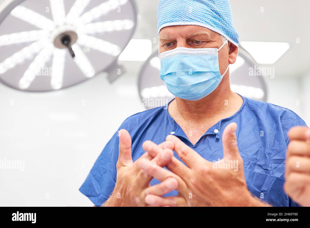 Senior surgeon as a concentrated chief physician with a face mask when ...