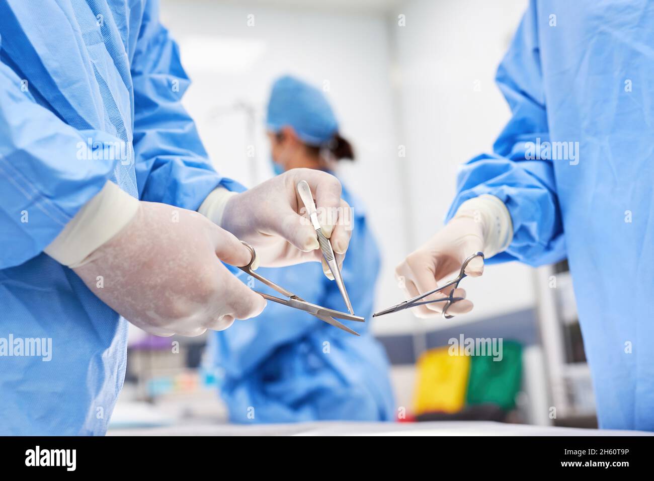 Surgeons hold various surgical instruments ready for an operation in ...
