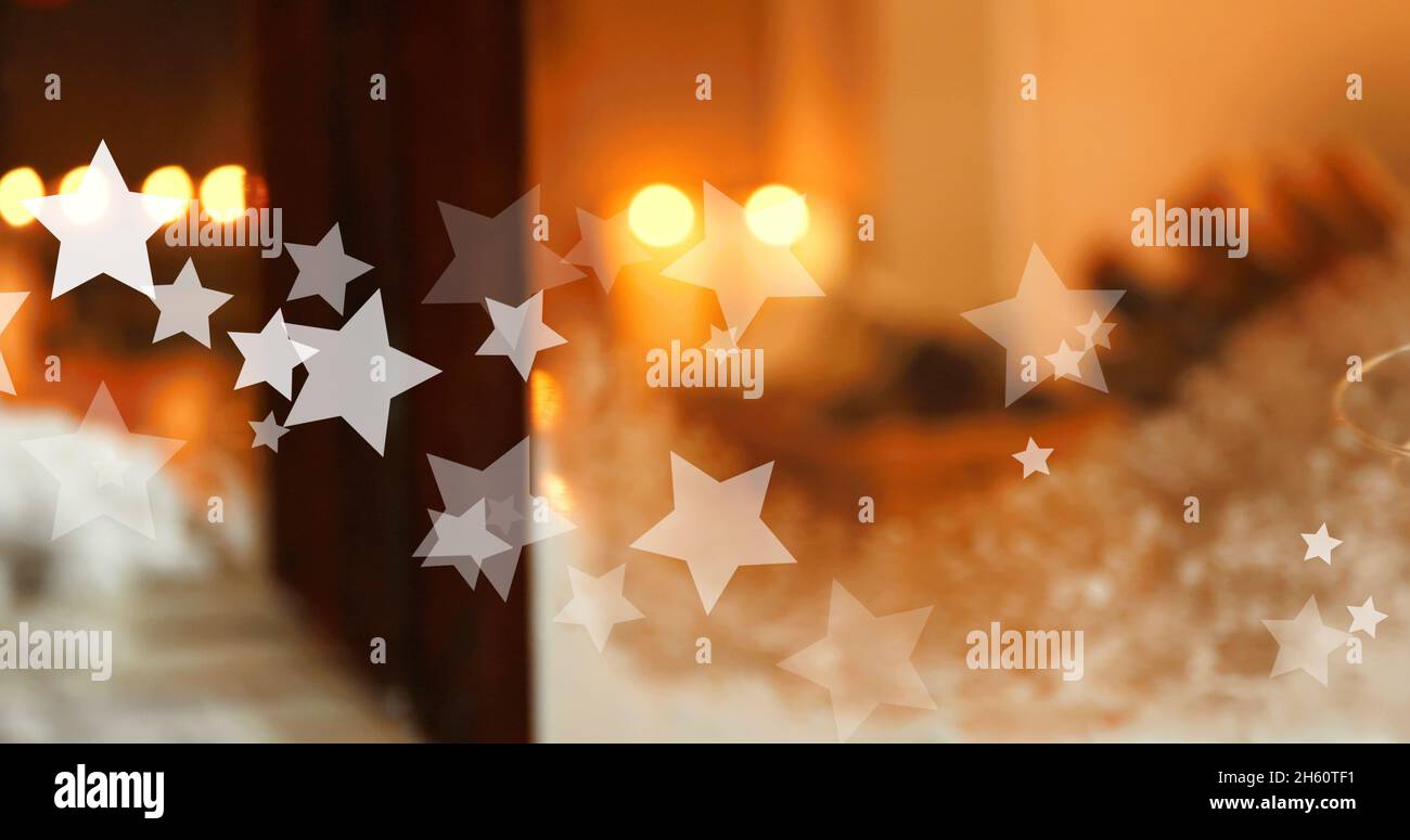Image of stars falling over candles and window at christmas Stock Photo ...
